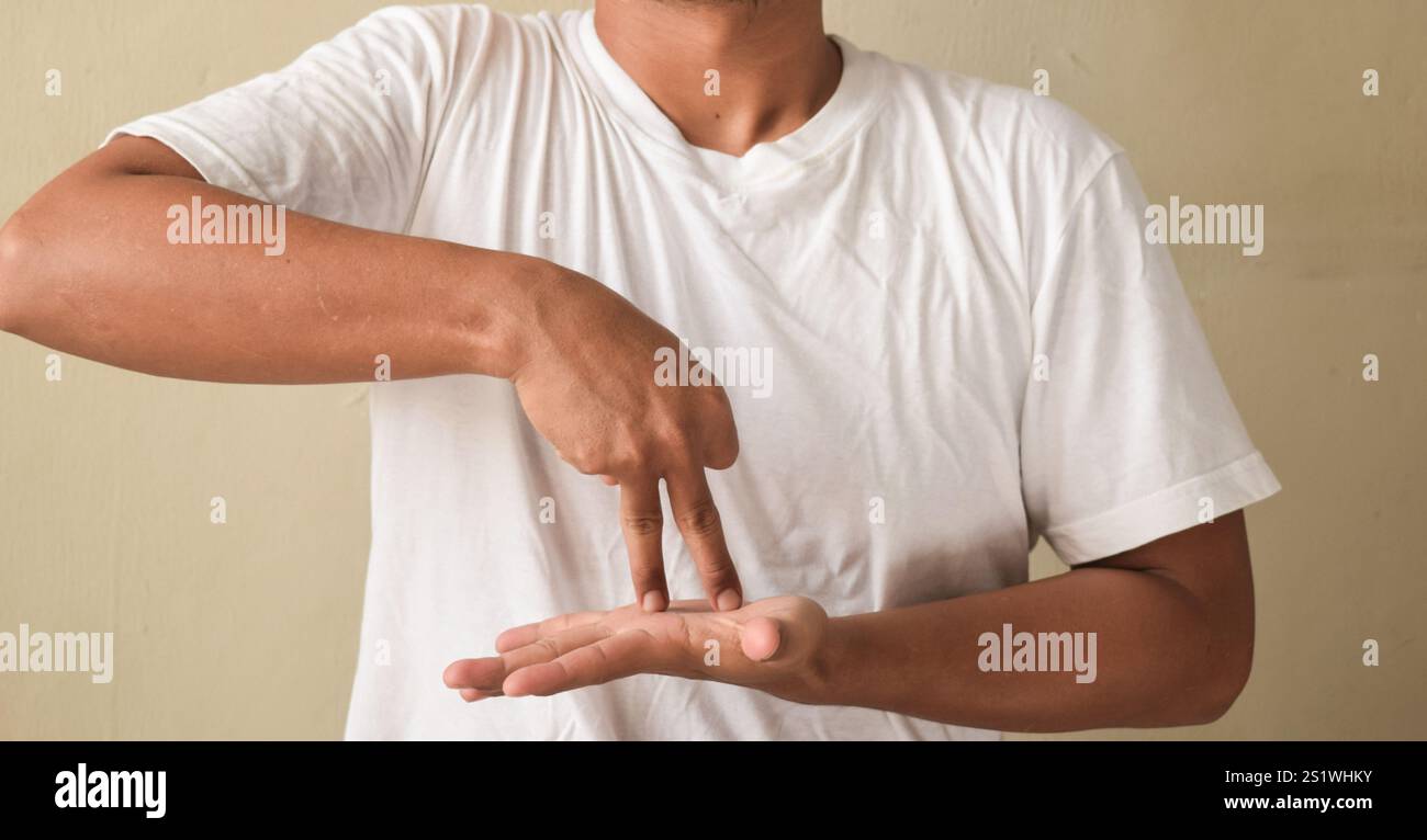 young man showing sign language with hand gestures speaking body ...