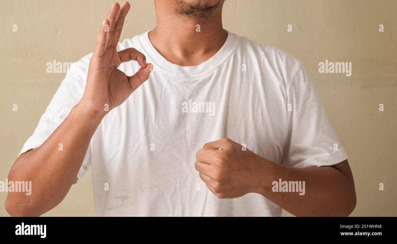 young man showing sign language with hand gestures speaking body ...