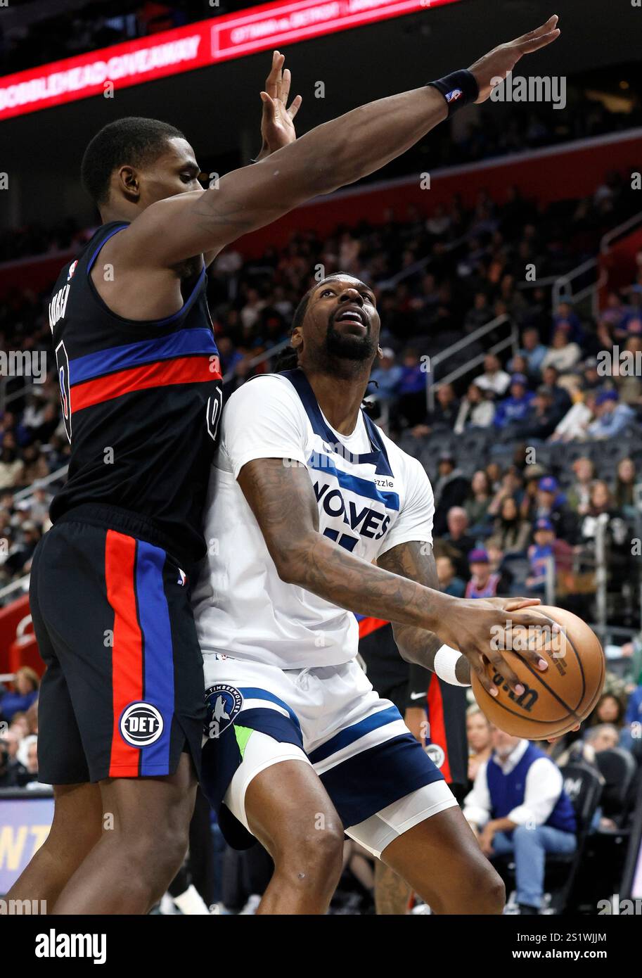 Minnesota Timberwolves center Naz Reid, right, tries to get a shot off ...