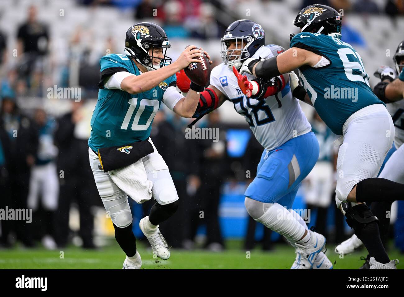 Jacksonville Jaguars quarterback Mac Jones (10) scrambles away from ...