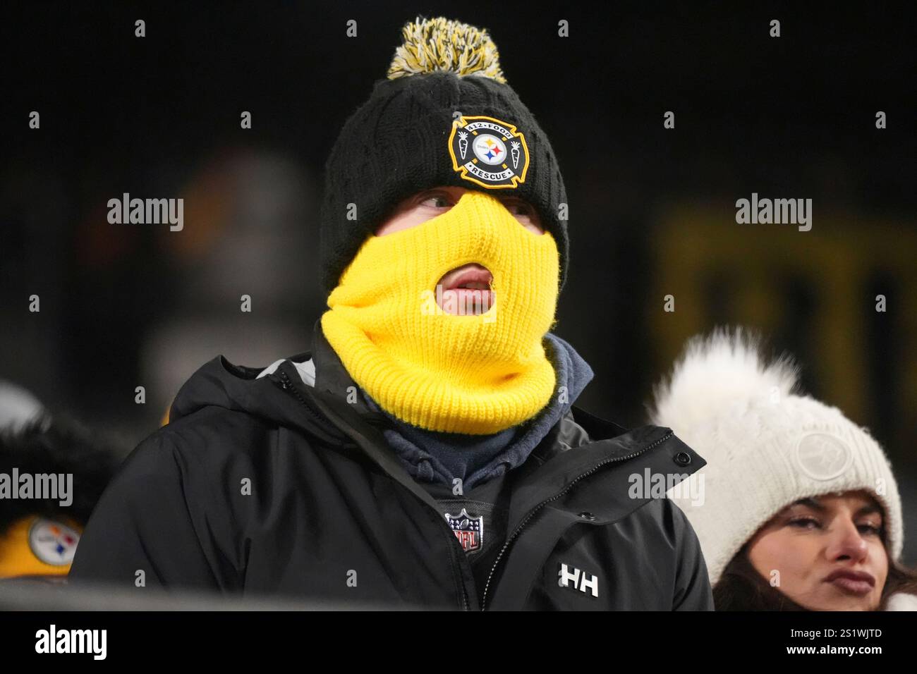 A Pittsburgh Steelers fan bundles against the cold during the second ...