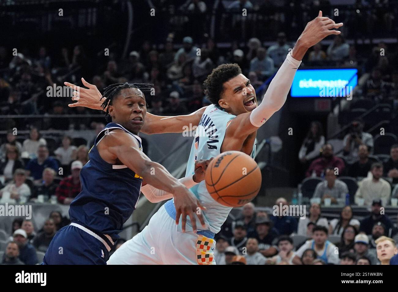 Denver Nuggets forward Peyton Watson, left, knocks the ball away from ...