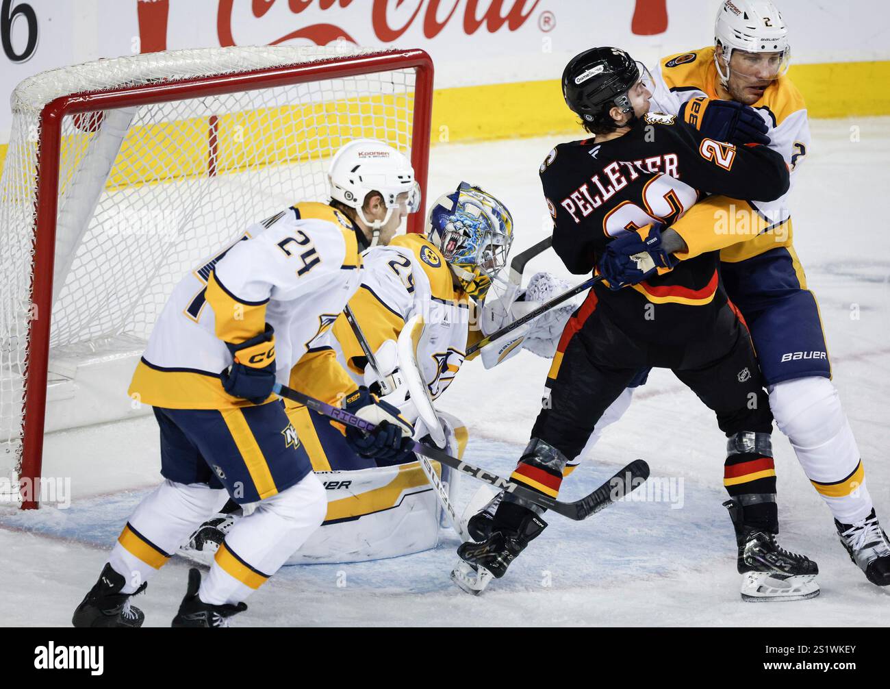 Nashville Predators' Luke Schenn, right, checks Calgary Flames' Jakob ...