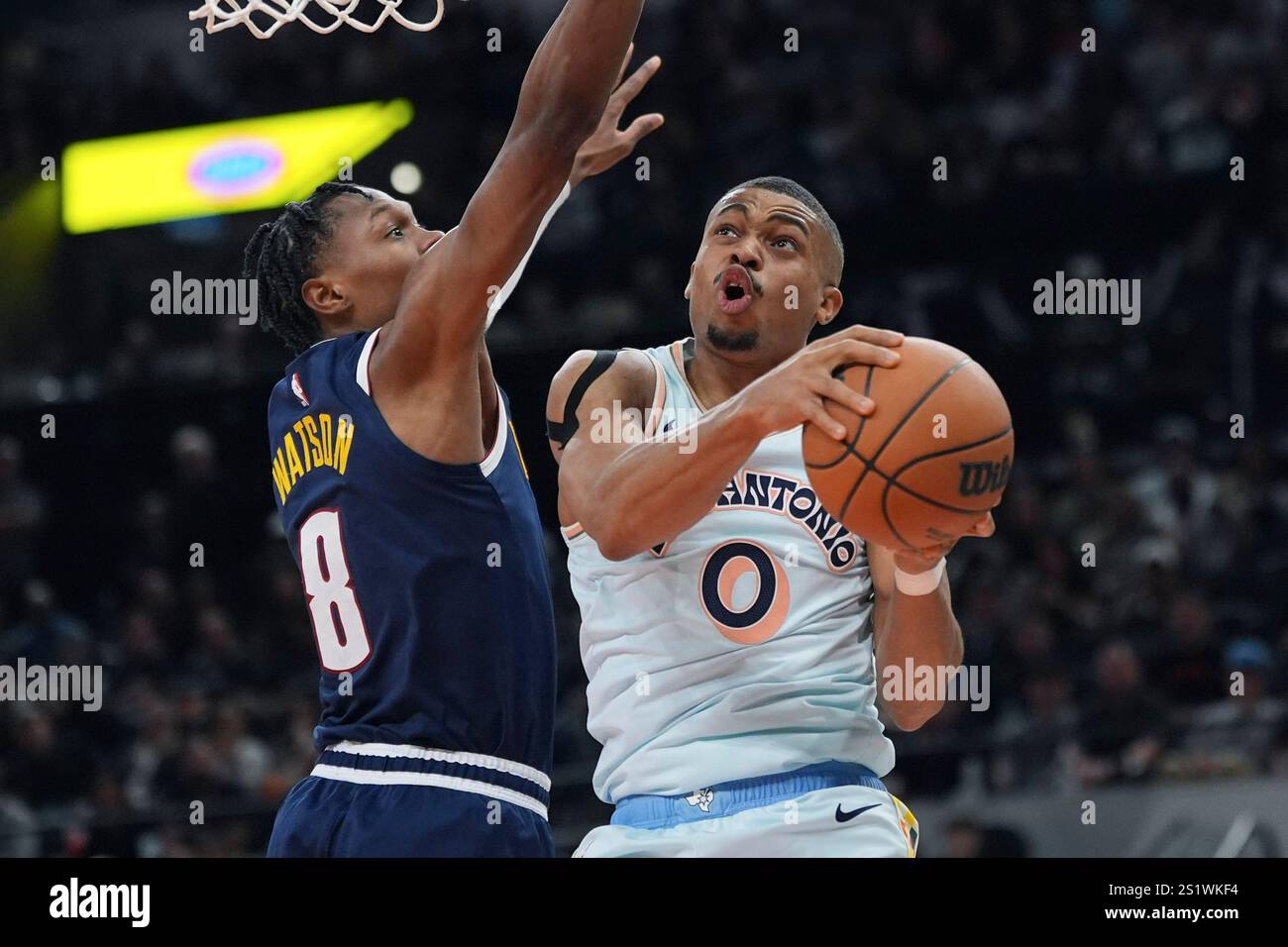 San Antonio Spurs forward Keldon Johnson (0) looks to shoot against ...