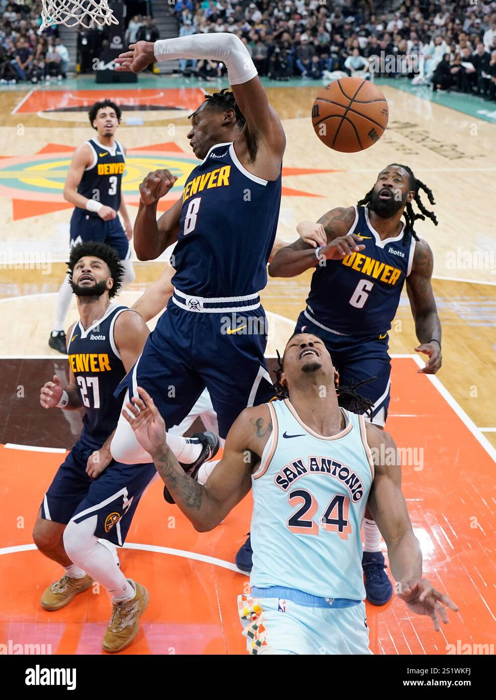 San Antonio Spurs guard Devin Vassell (24) is fouled by Denver Nuggets forward Peyton Watson (8 ...
