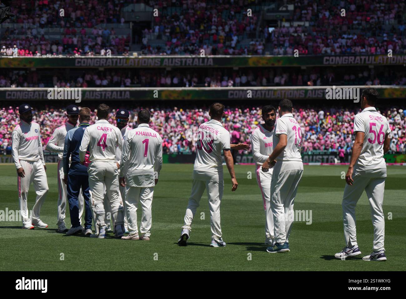 Australian and Indian players shake hands at the end of play in the ...