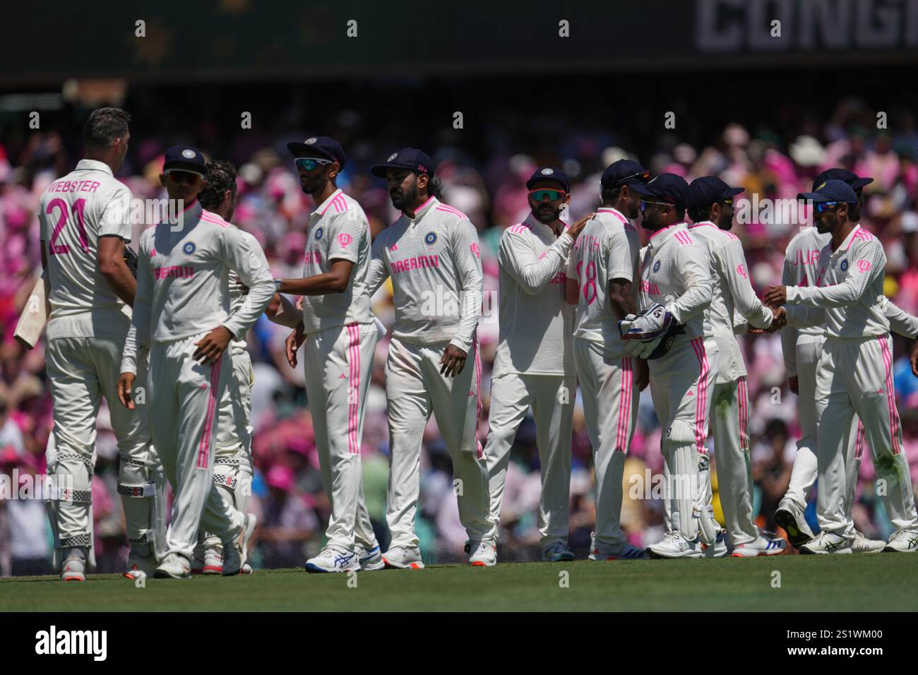 Australian and Indian players shake hands at the end of play in the ...