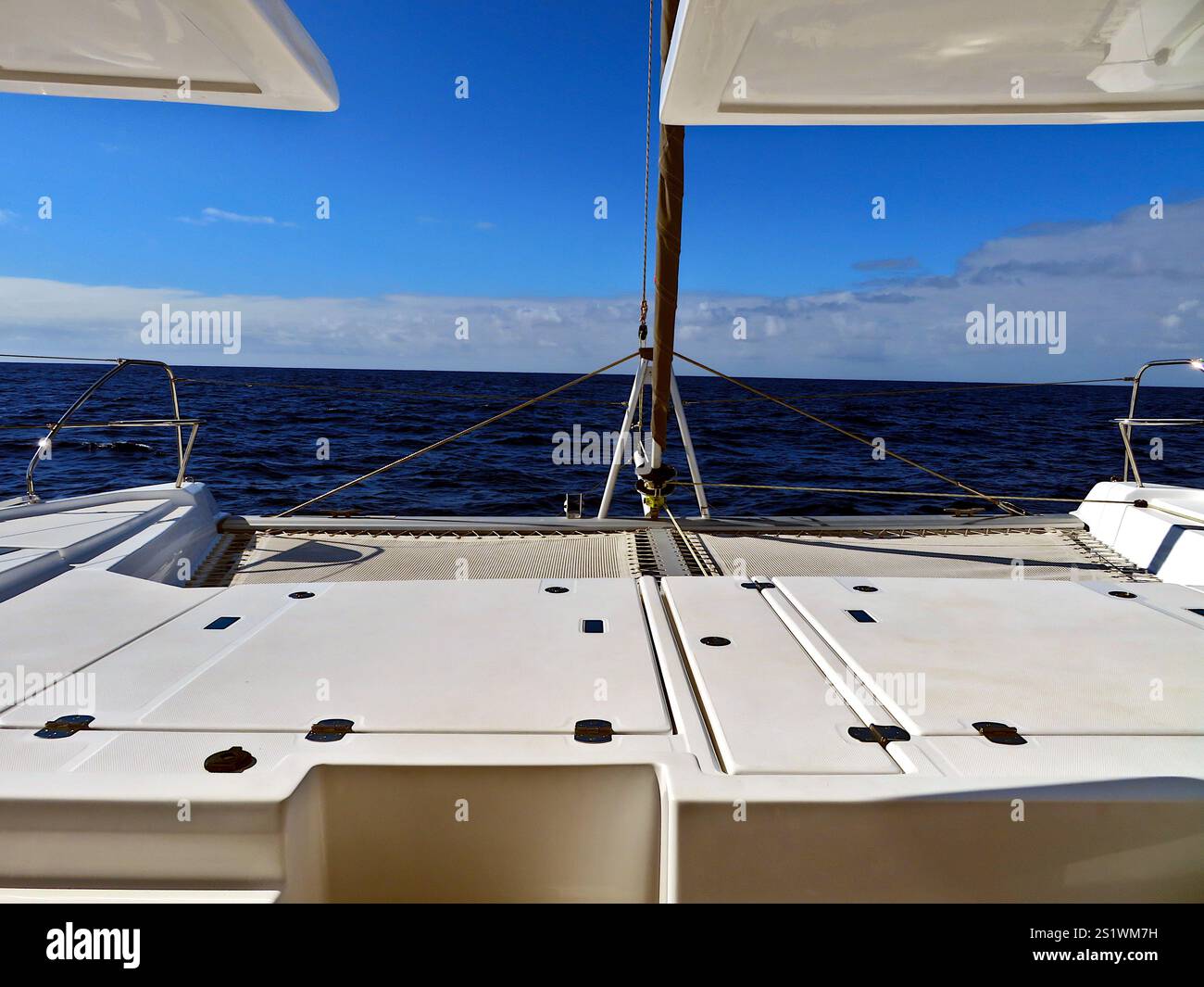 The sleek bow of a catamaran cutting through the open waters of the ...
