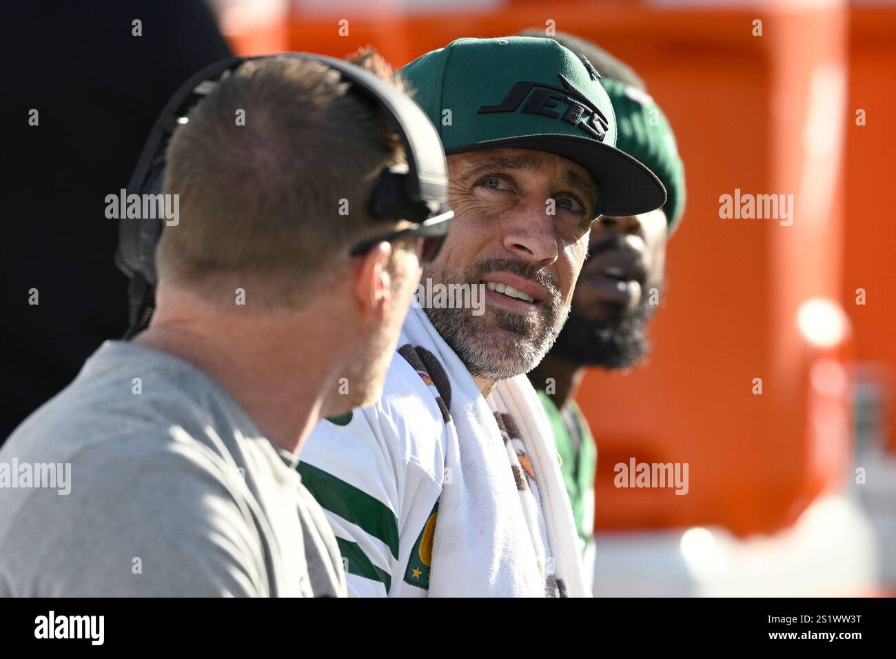 New York Jets quarterback Aaron Rodgers, center, looks on from the ...