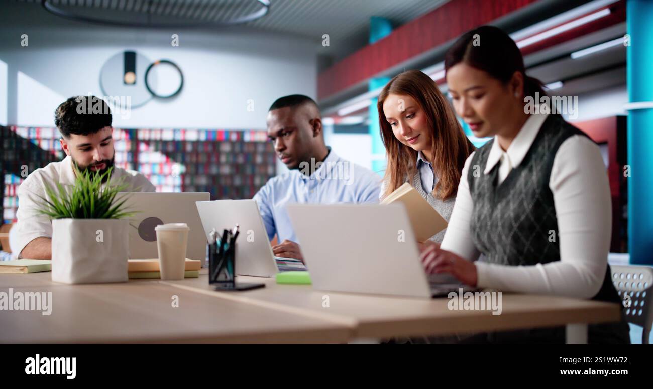 Students Learning Online At University Library Using Laptops Stock ...