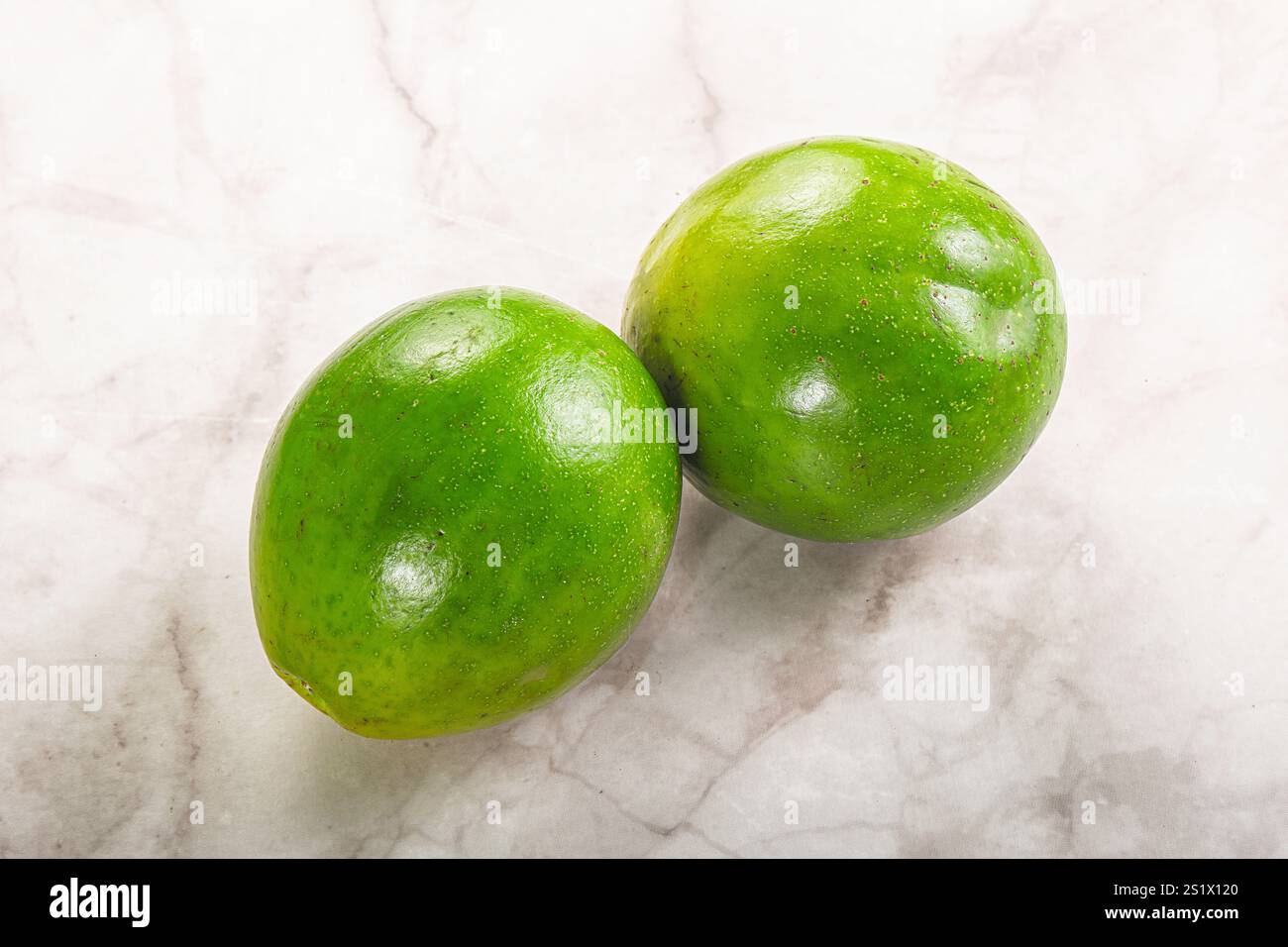 Two ripe green exotic avocado whole fruit Stock Photo - Alamy