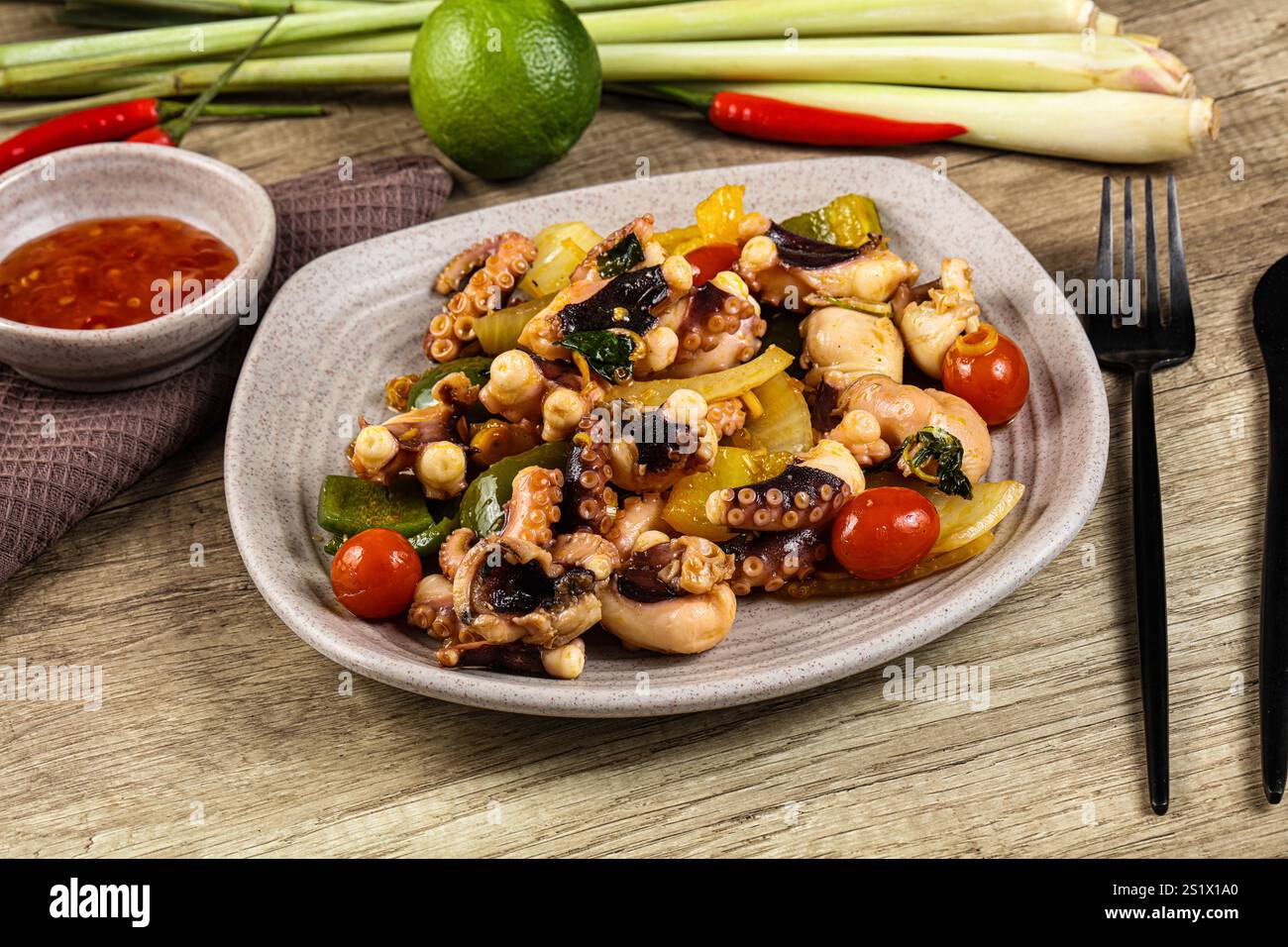 Roasted octopus with vegetables, spices and oil Stock Photo - Alamy