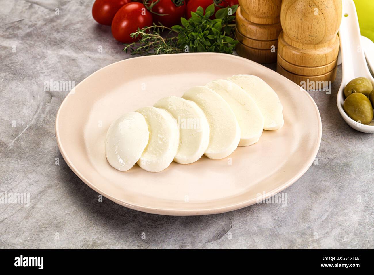Organic mozzarella cheese slices in the plate appetizer Stock Photo - Alamy