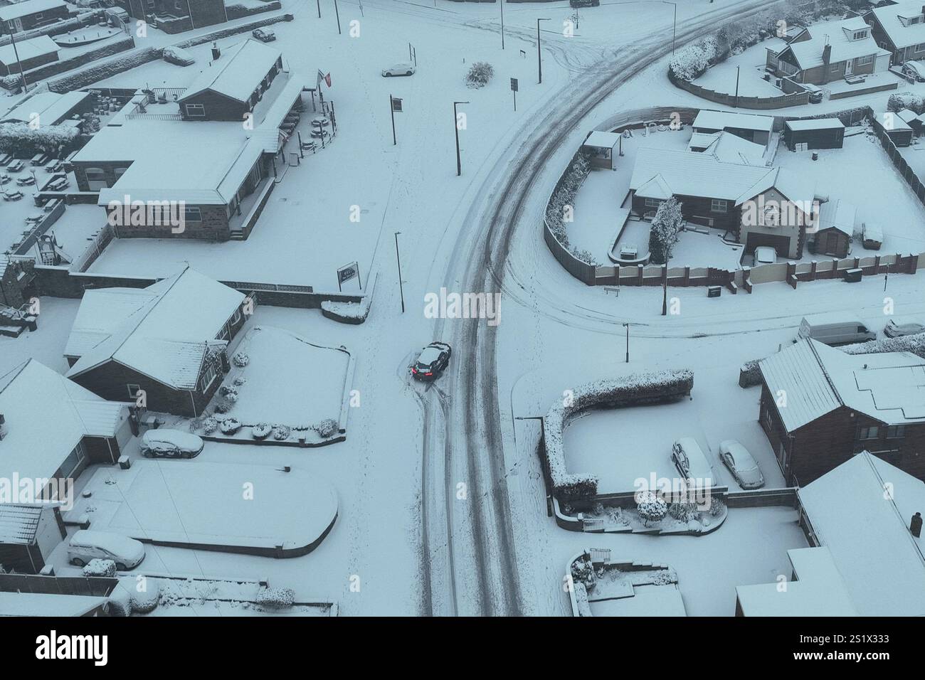 Barnsley, UK. 05th Jan, 2025. A car gets stuck in the snow as heavy ...