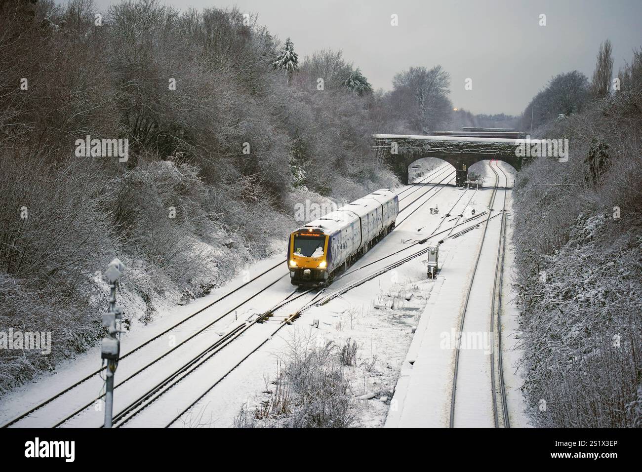 A train makes its way along the Hunt's Cross line in Liverpool. Heavy ...