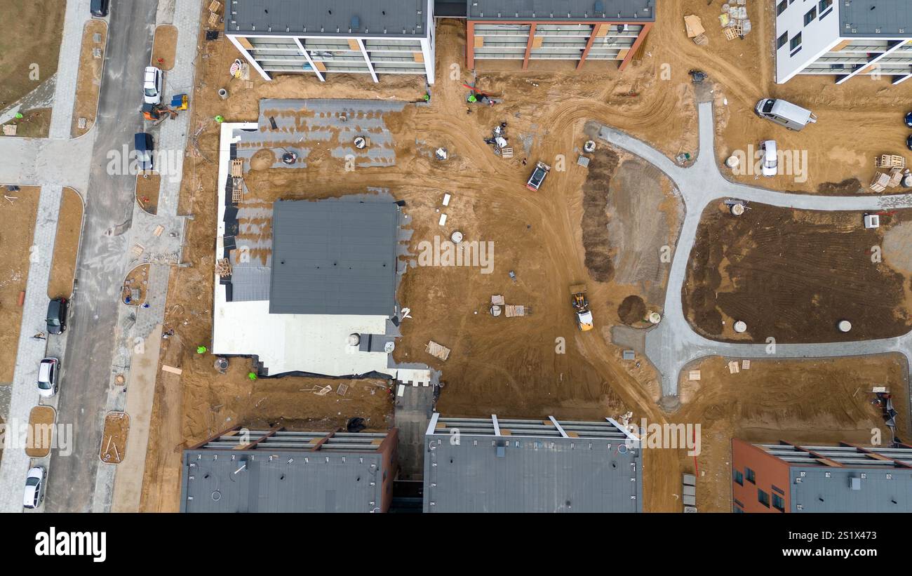 Aerial view of a construction site with multiple buildings and vehicles ...