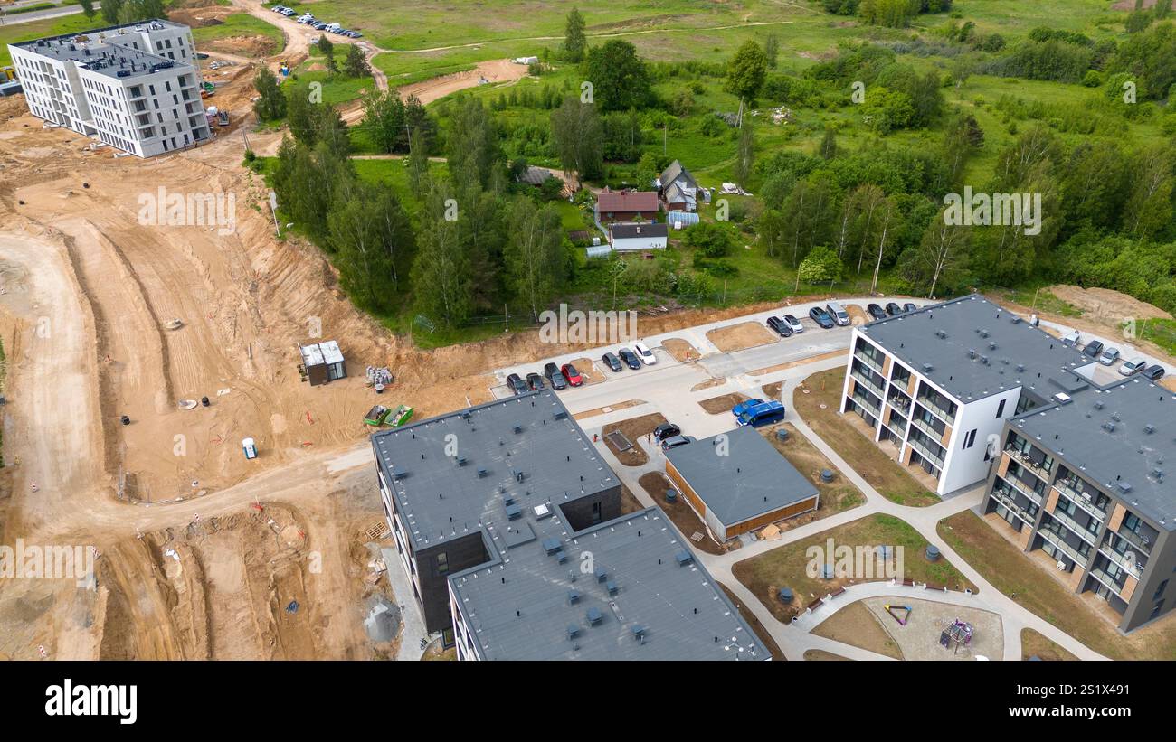 Aerial view of a residential construction site with modern apartment buildings surrounded by ...