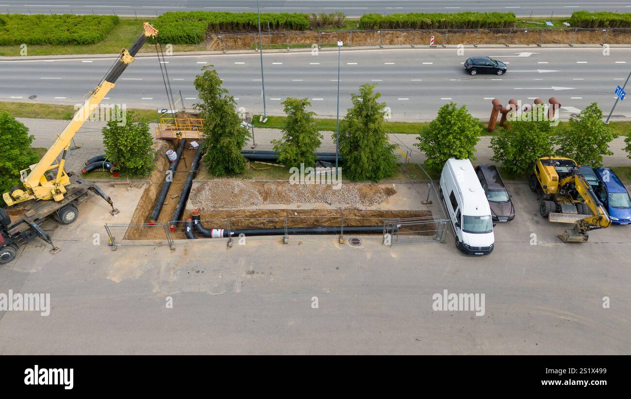 Aerial view of a pipeline construction site near a road with heavy ...