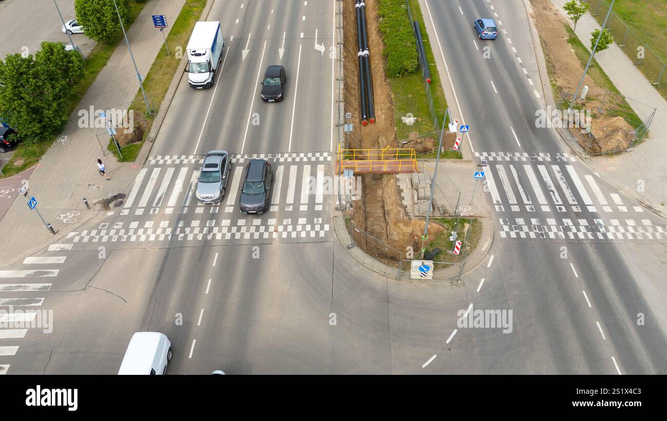 Aerial view of a busy urban intersection with vehicles, pedestrian ...