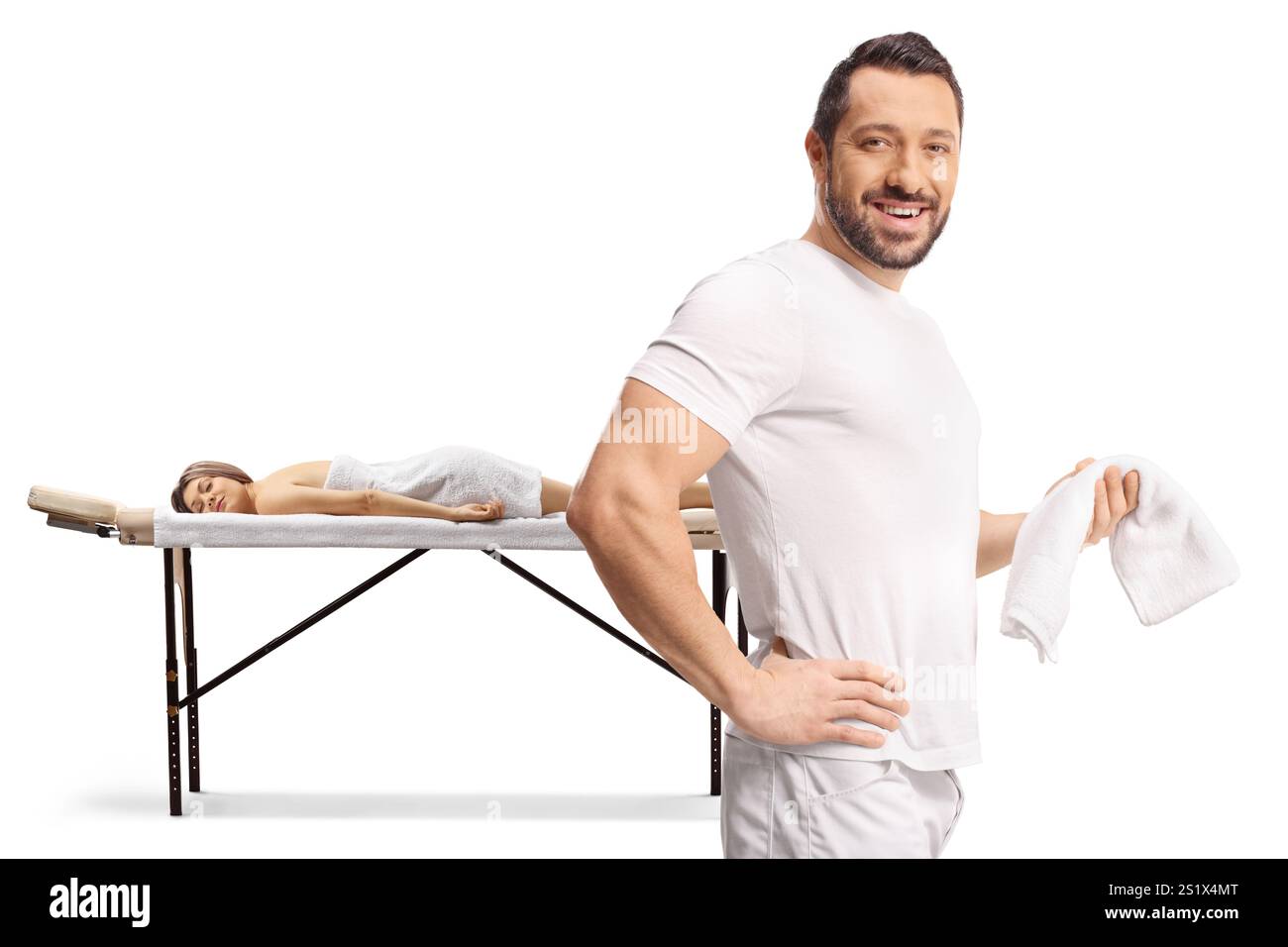 Massage therapist holding a towel in front of a woman on a massage ...