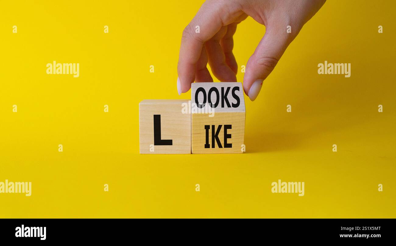 Looks like symbol. Businessman hand Turnes cubes with words Looks like ...