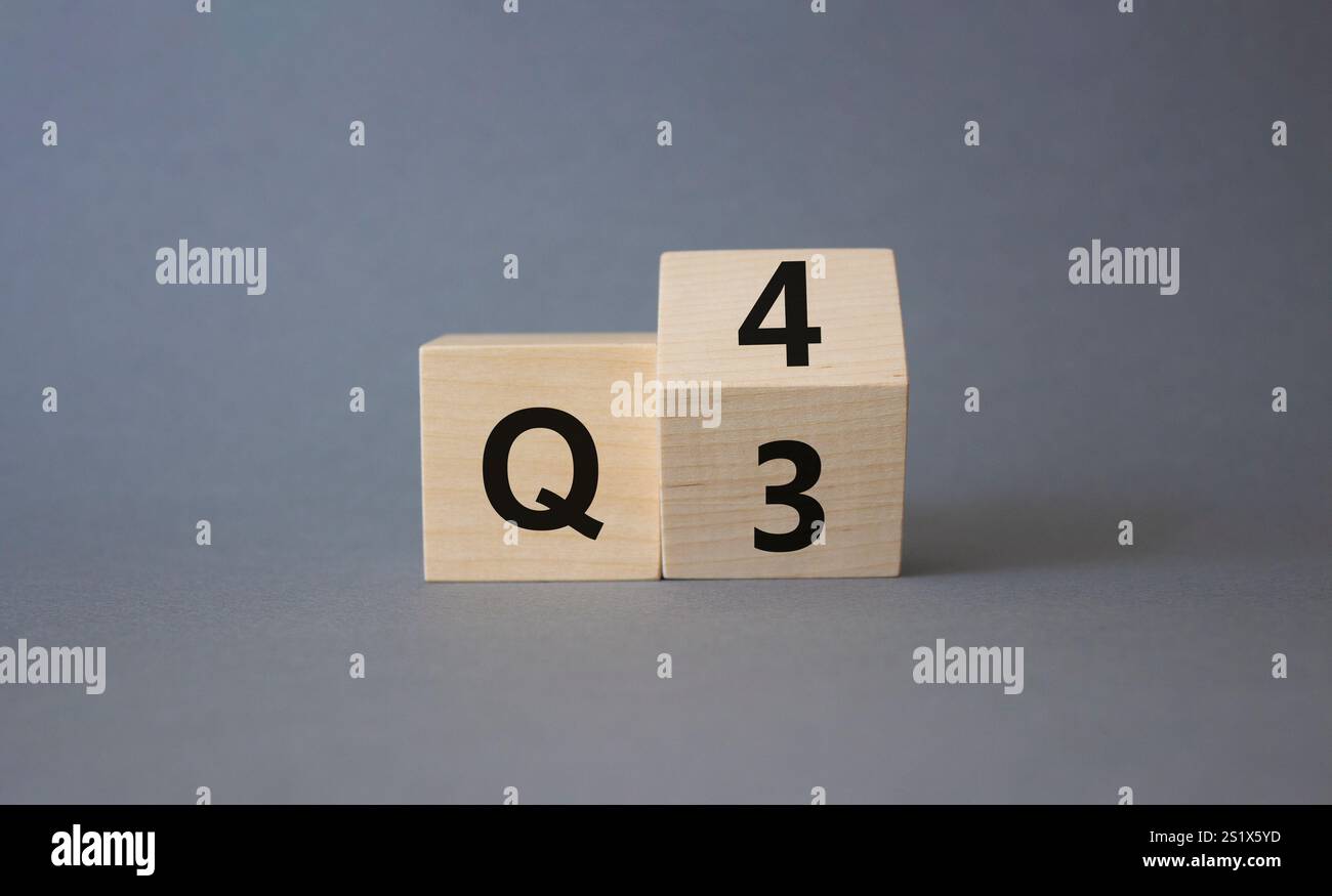 From 3rd Quarter to 4th symbol. Turned wooden cubes with words 3rd ...
