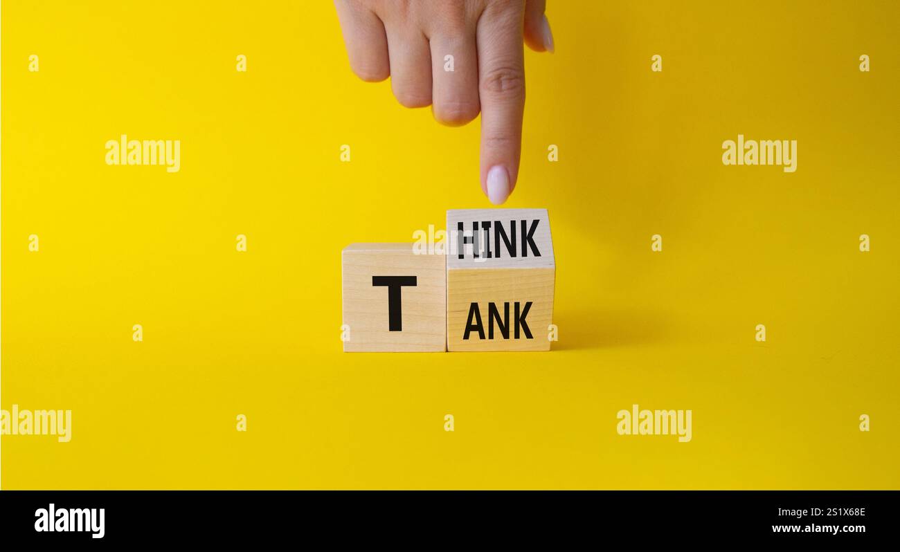 Think Tank symbol. Businessman hand points at turned wooden cubes with ...