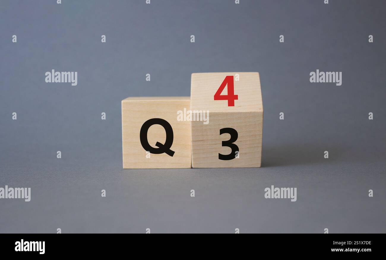 From 3rd Quarter to 4th symbol. Turned wooden cubes with words 3rd ...