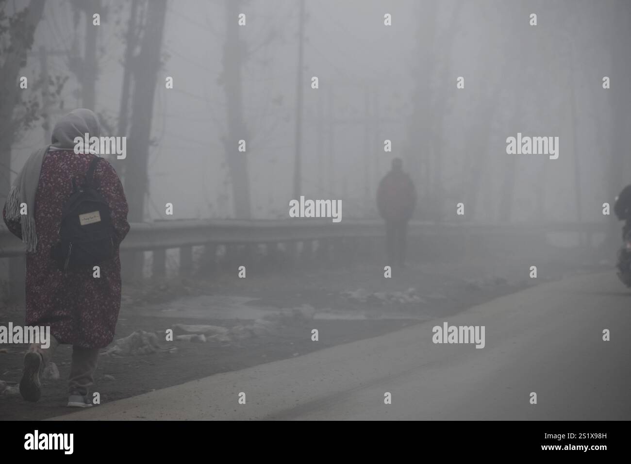 Non Exclusive: People walking through the fog due to freezing cold ...
