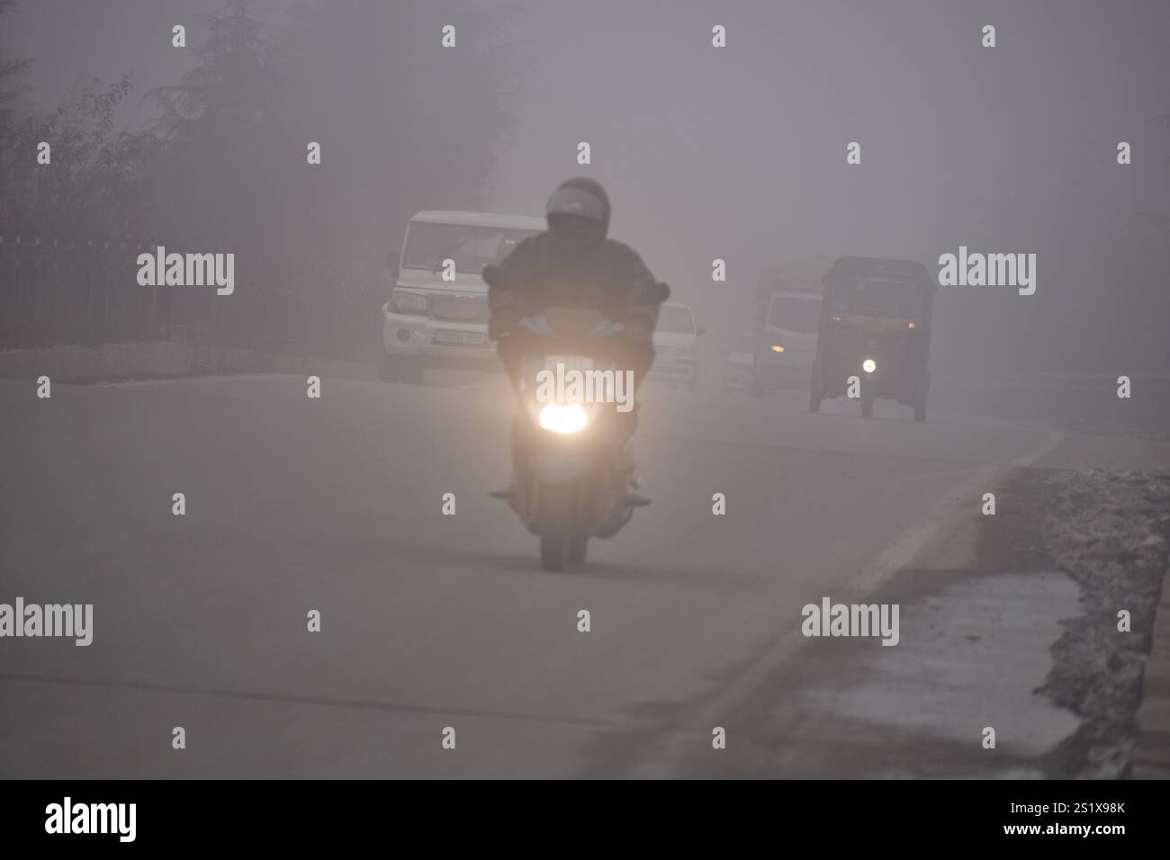 Non Exclusive: Vehicles are seen through the fog due to freezing cold ...