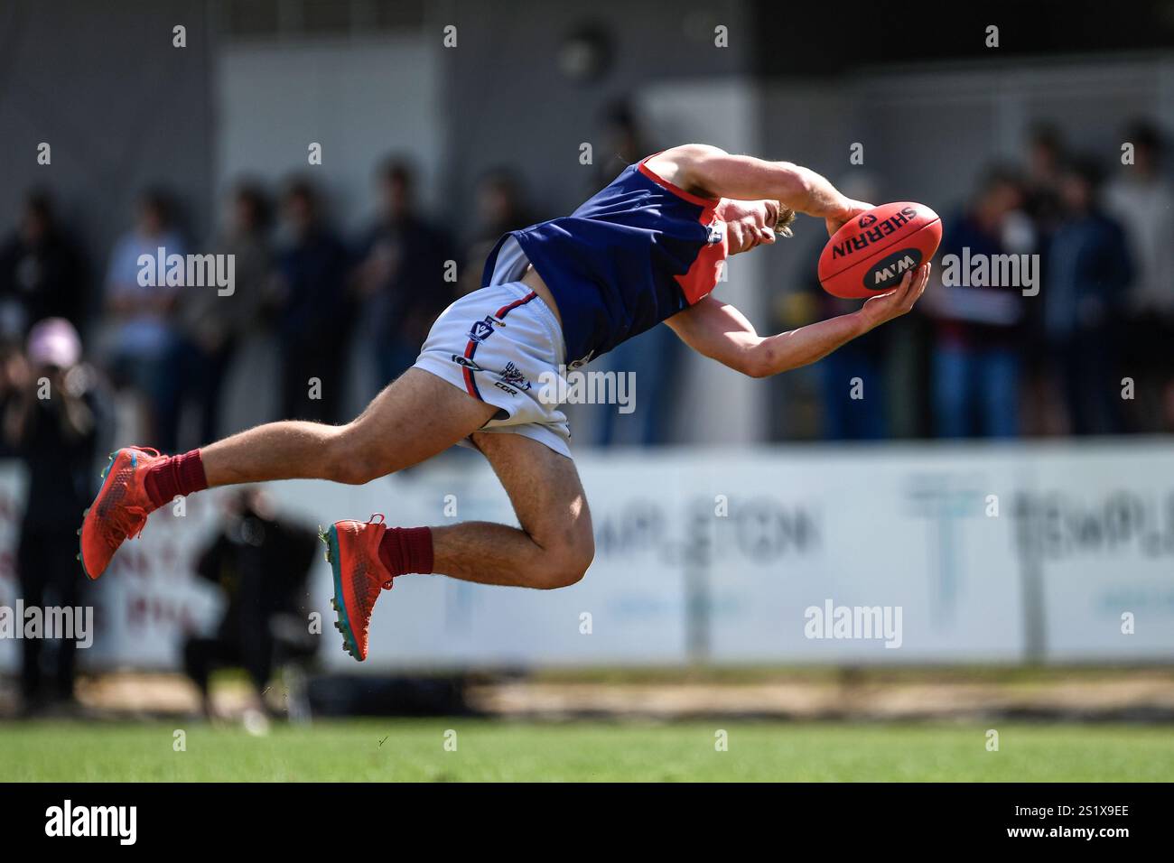 A Milawa Reserves Australian football player stretches in the air to ...
