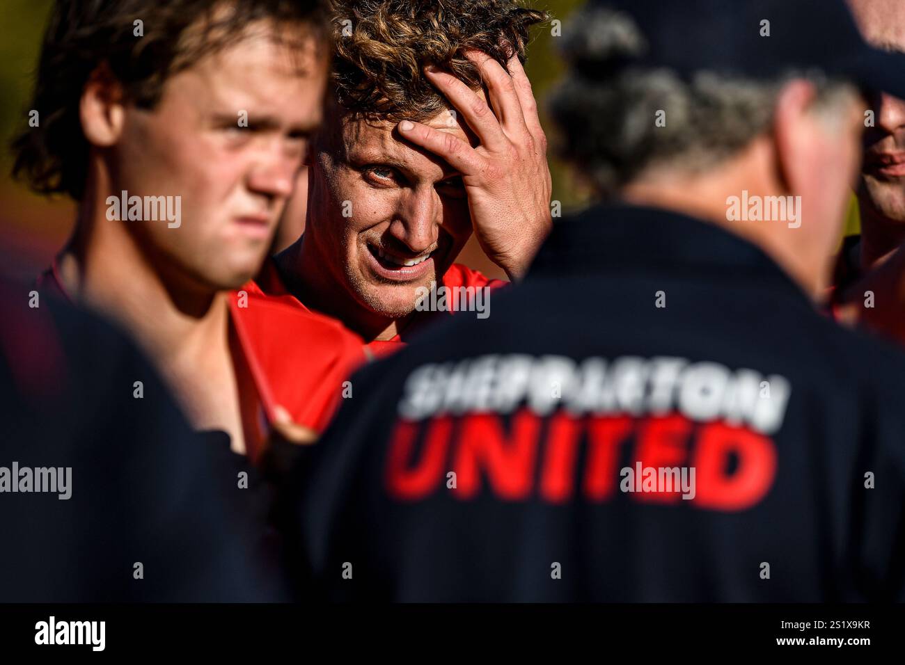 Facing defeat a frustrated Australian rules football player holds his ...