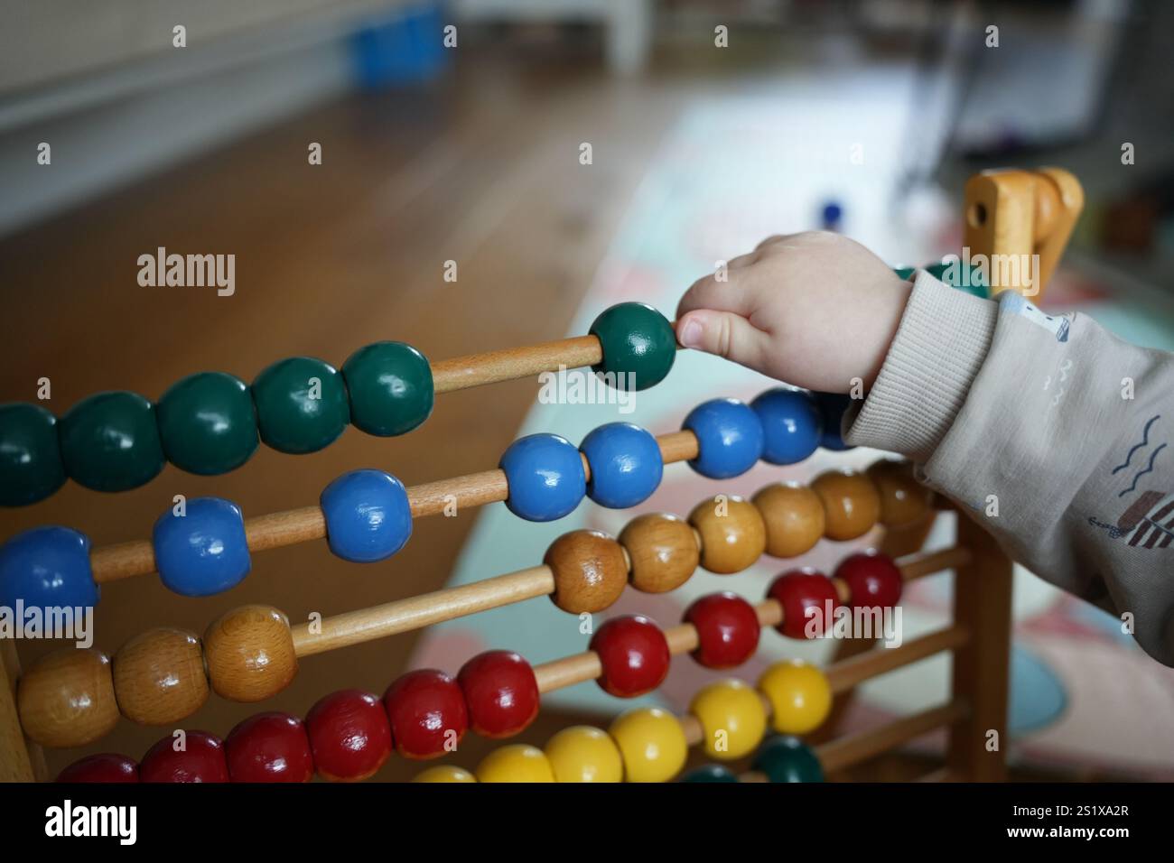 Toddler or baby playing with the abacus learning mathematics. Child ...