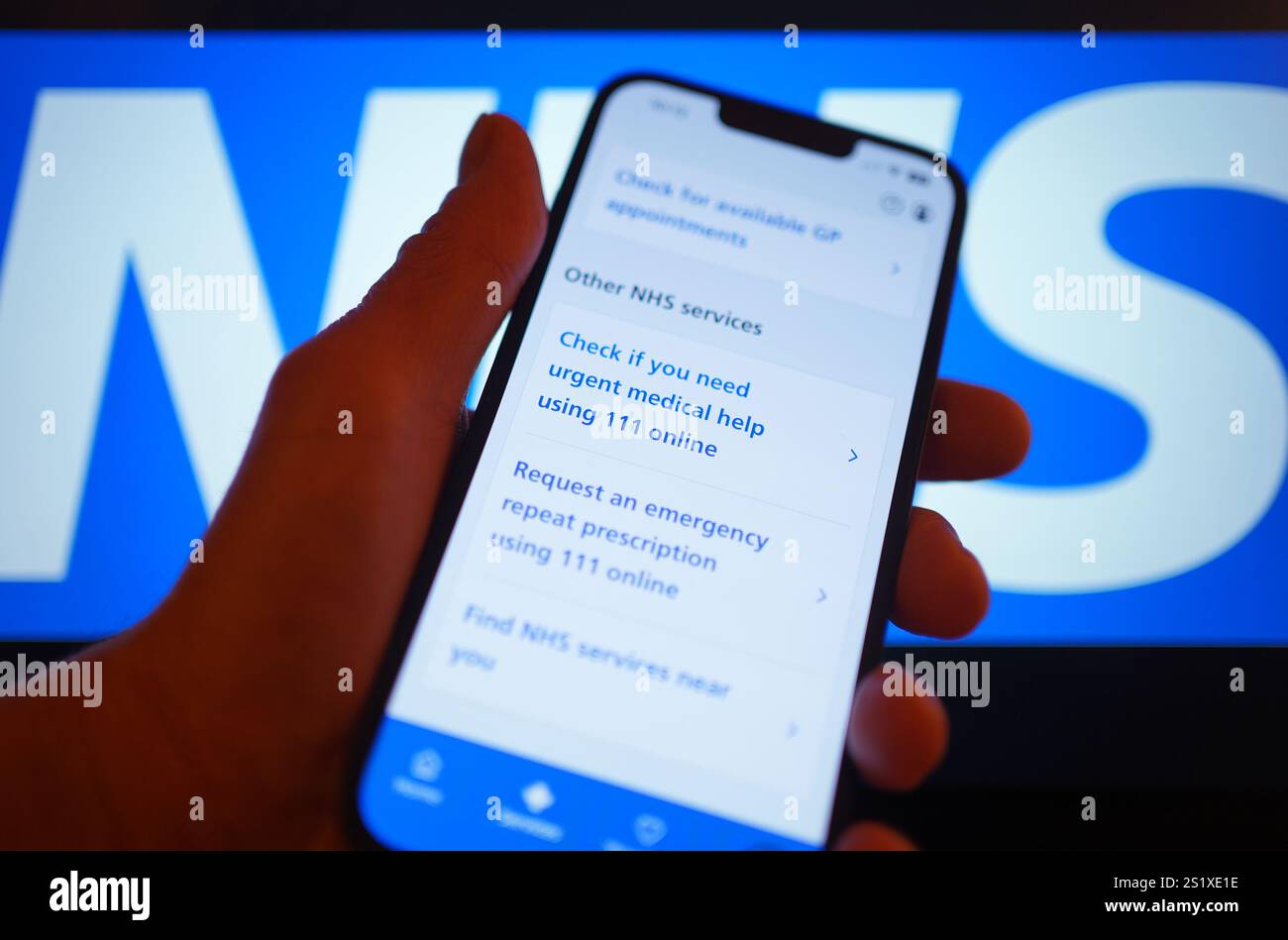 A person views the NHS app on a mobile phone. More NHS patients who ...
