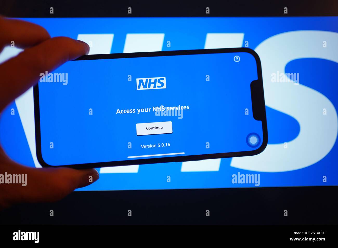 A person views the NHS app on a mobile phone. More NHS patients who ...