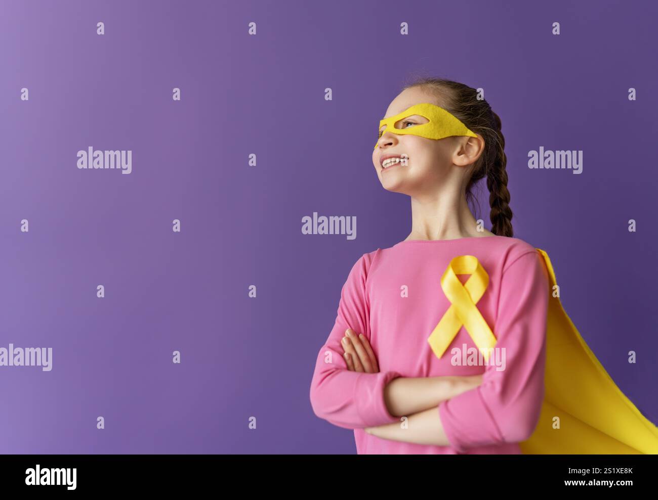 World Childhood cancer Day. Girl in superhero costume with golden ...