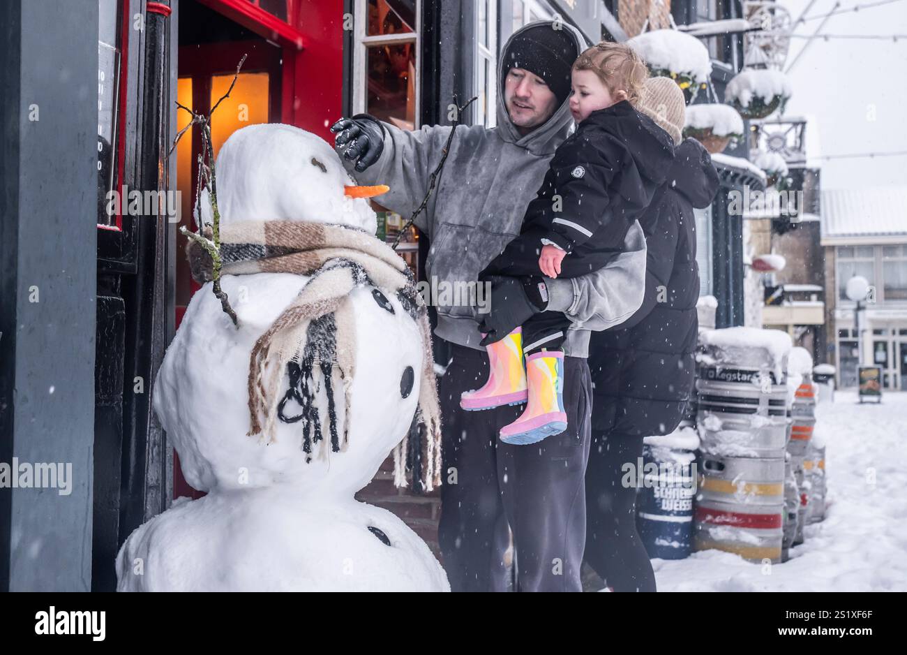 Christian Ogley with his daughter Noa Ogley as they make a snowman in ...