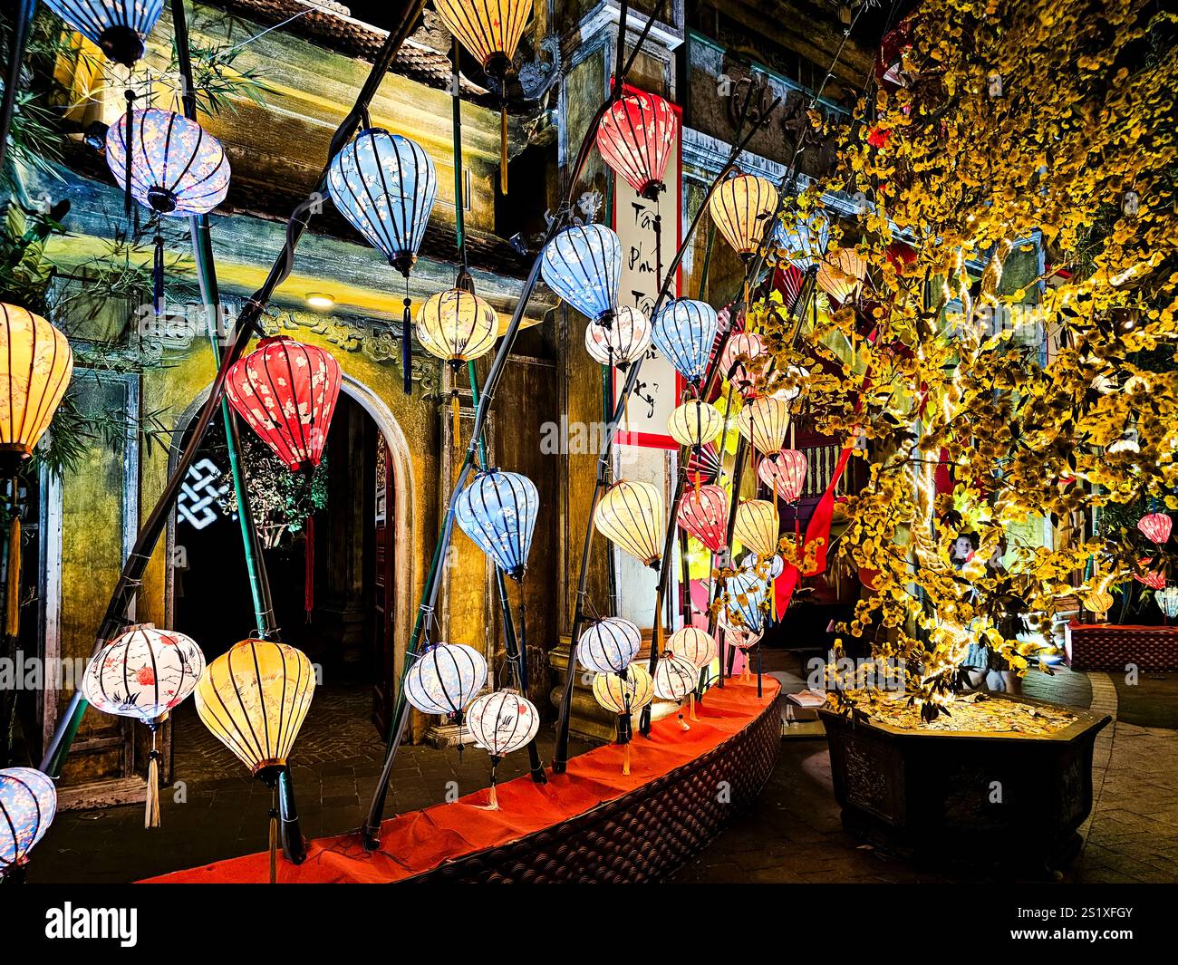 A row of lanterns hang from the ceiling. The lanterns are of different ...