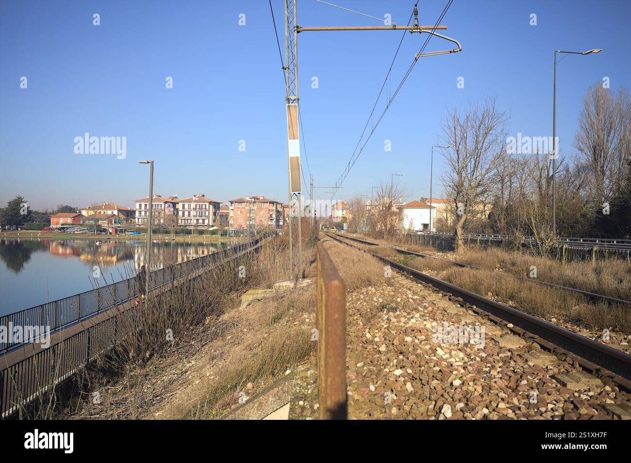 Railroad track on an embankment over a park by the lakeshore on a ...