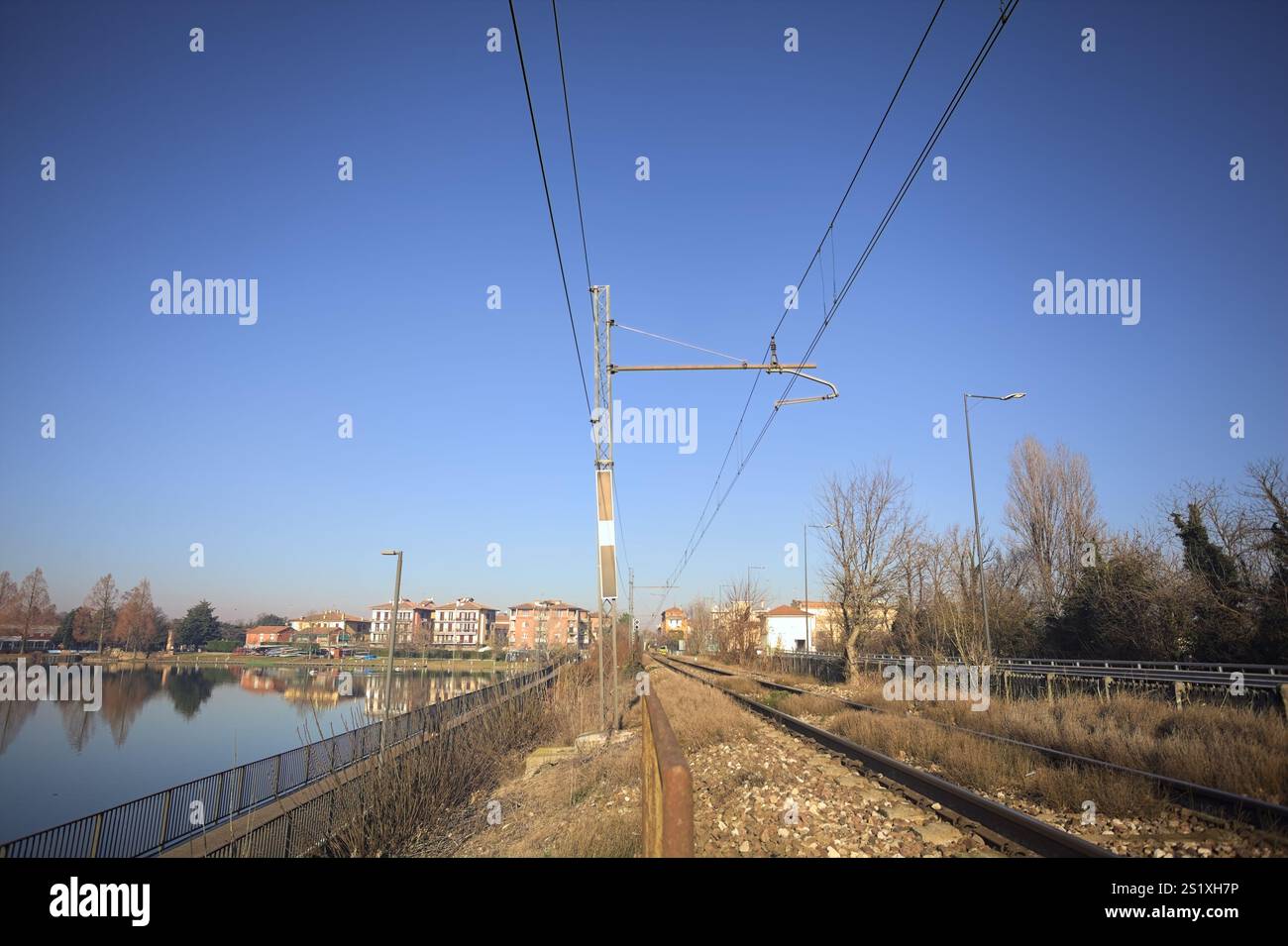 Railroad track on an embankment over a park by the lakeshore on a ...