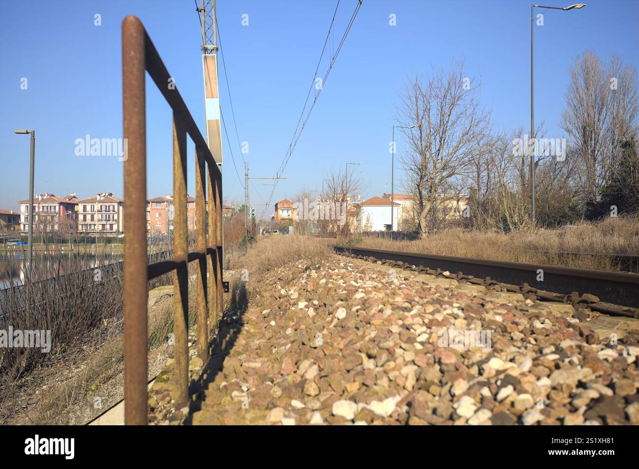Railroad track on an embankment over a park by the lakeshore on a ...