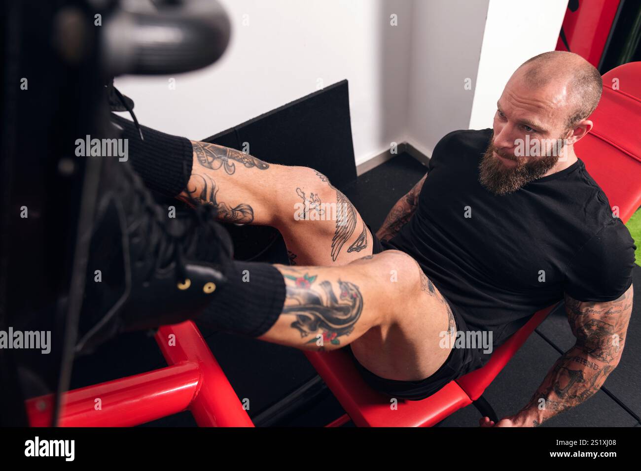 muscular sportsman training on leg press at gym Stock Photo - Alamy