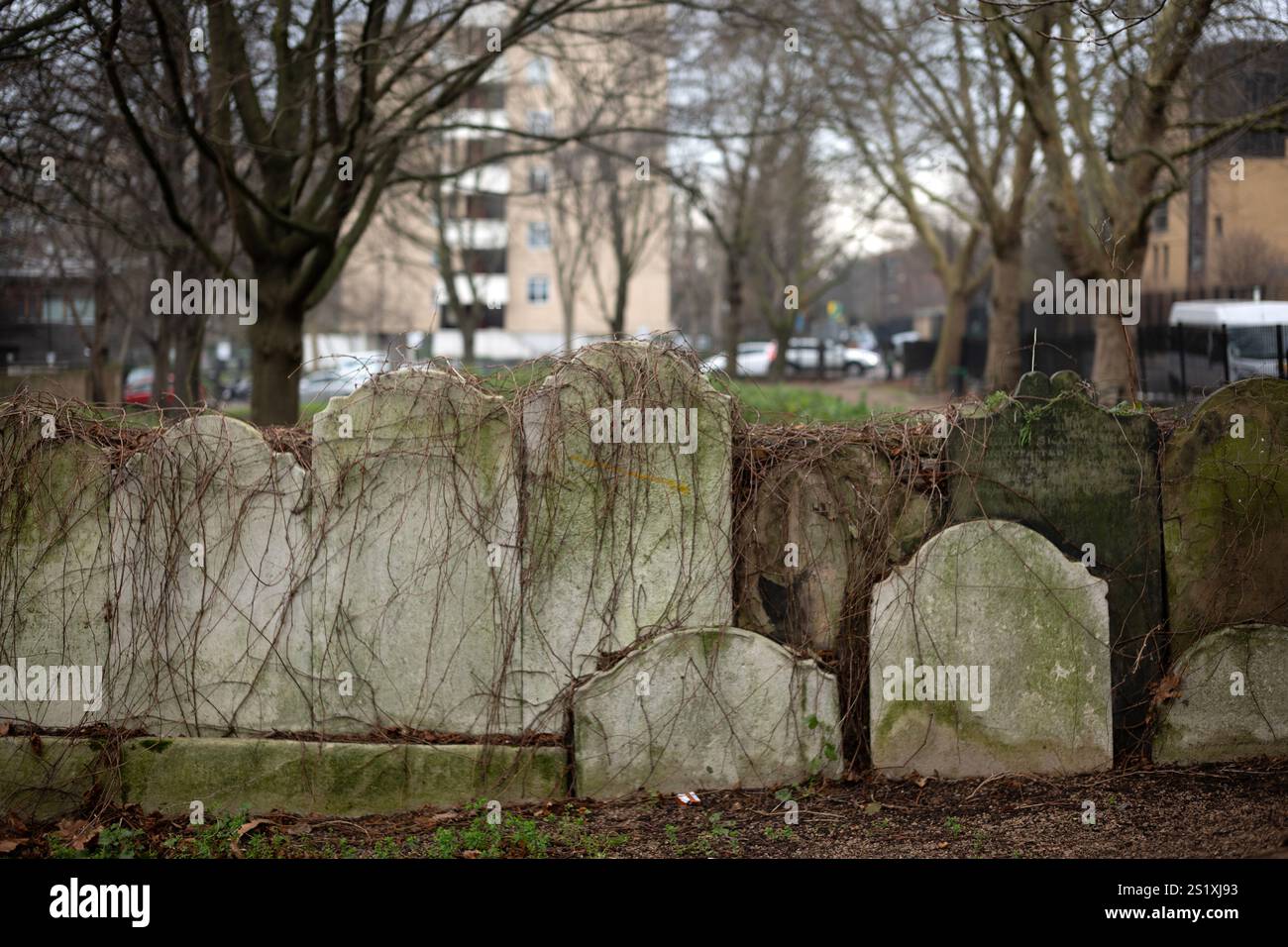 Old gravestones stacked against the wall of the Joseph Grimaldi park in ...