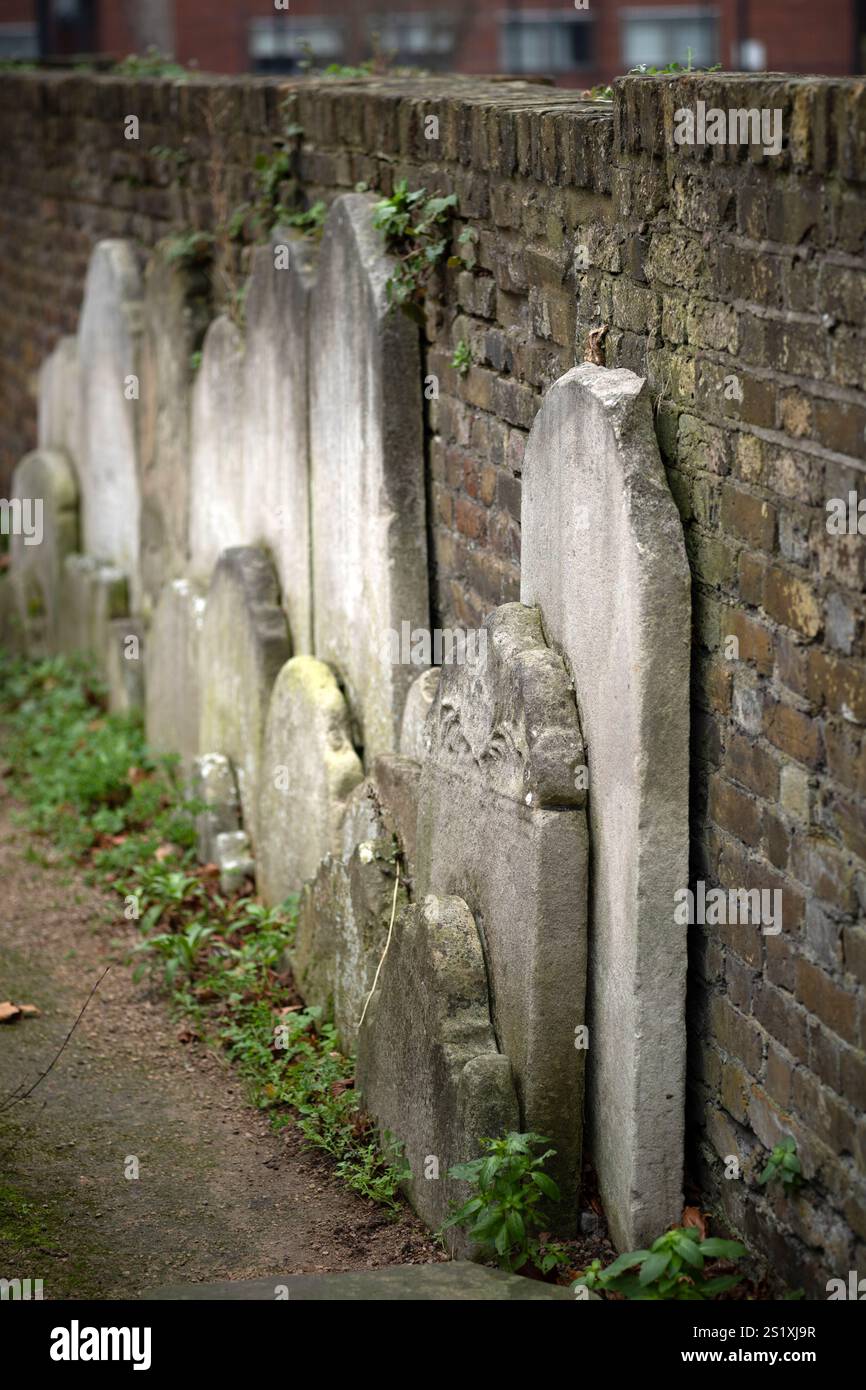 Old gravestones stacked against the wall of the Joseph Grimaldi park in ...