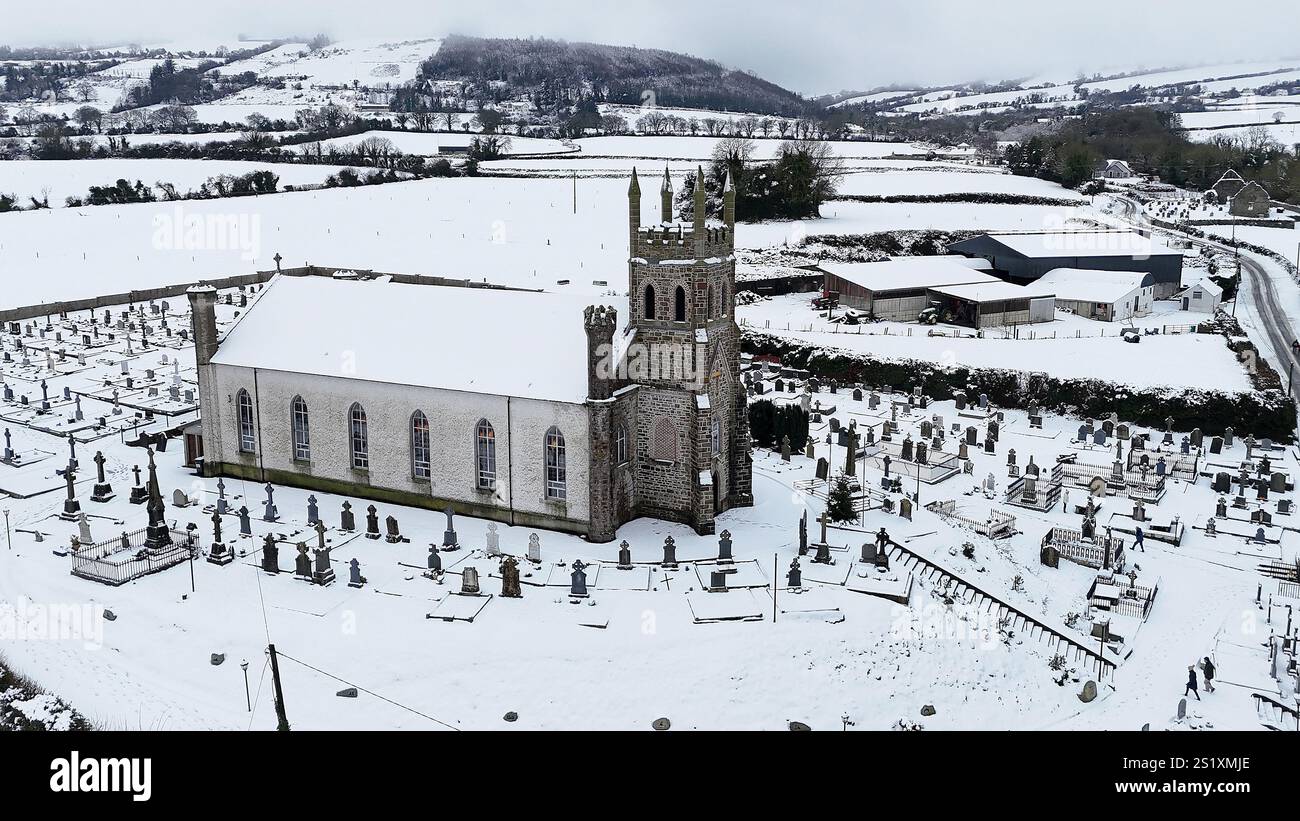 People make their way through snow to Mass at Holy Cross Catholic ...