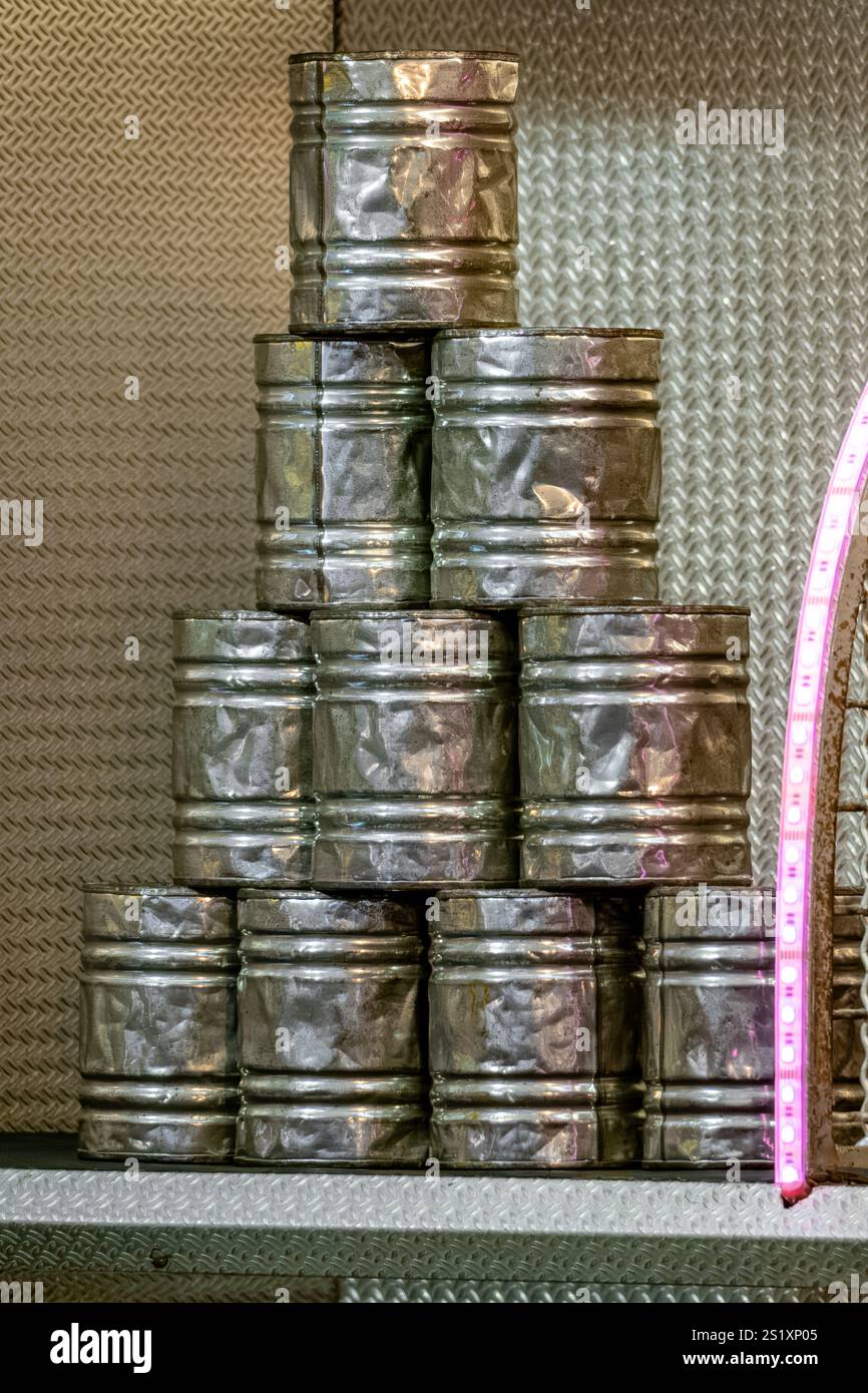 10 cans are stacked to throw a ball at at the funfair Stock Photo - Alamy
