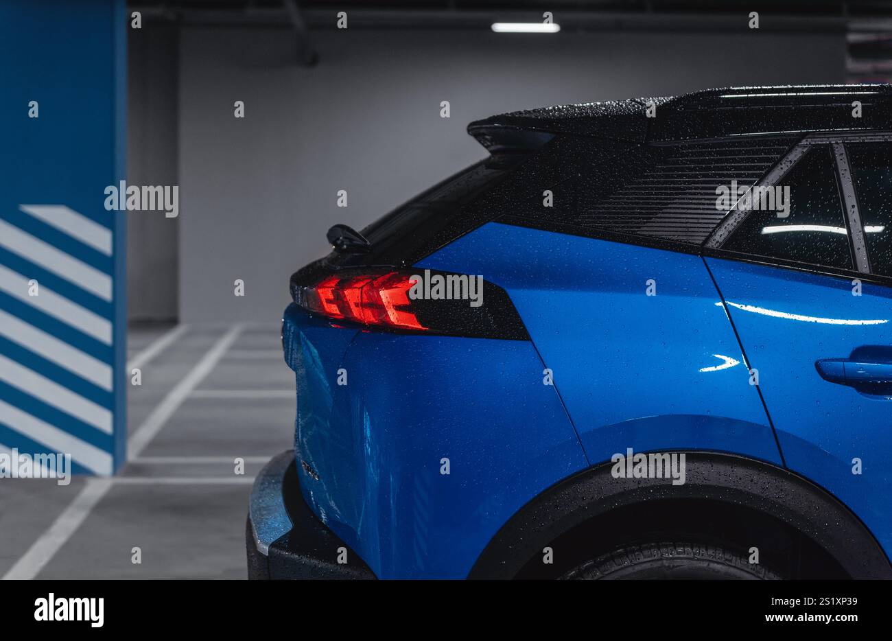 lue Peugeot 2008 in parking garage. Close-up rear quarter panel side ...