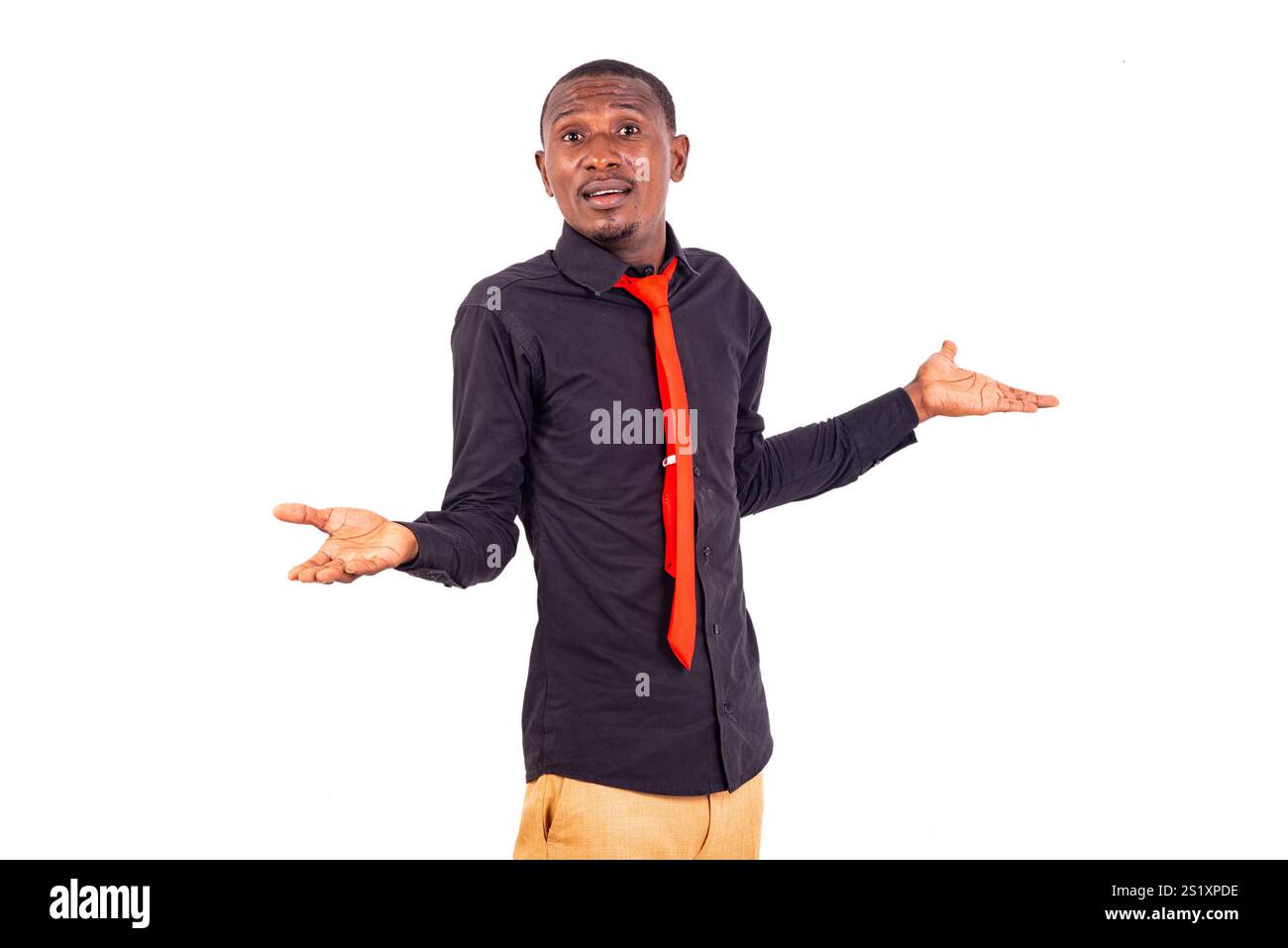 portrait of an unsure young businessman shrugging his shoulders and ...