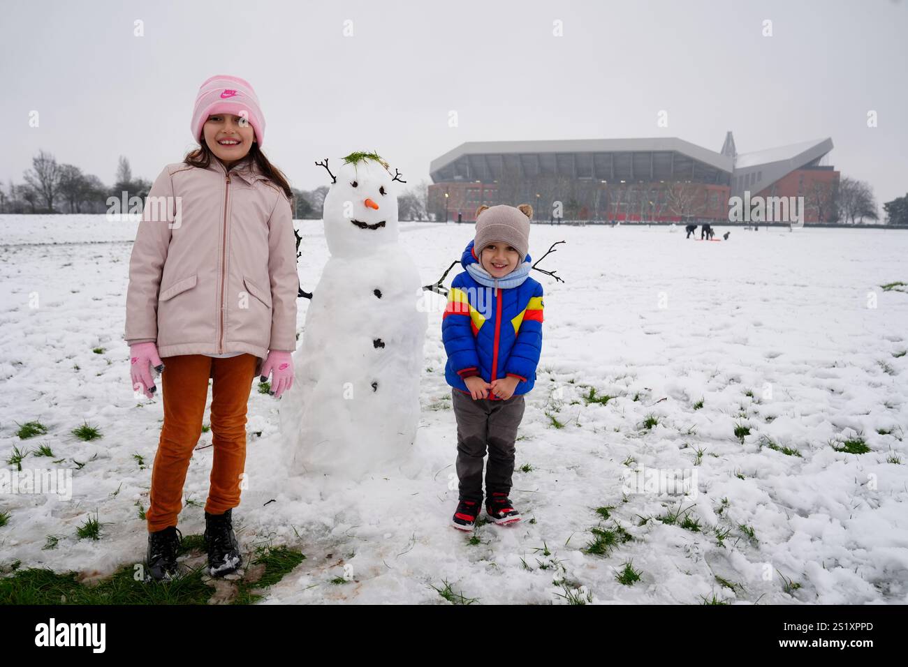People play in the snow in Stanley Park at Anfield in Liverpool. Heavy ...