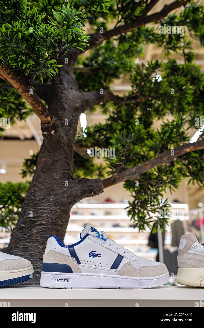 Shoes of the Lacoste company with the brand logo on the shelf of the ...